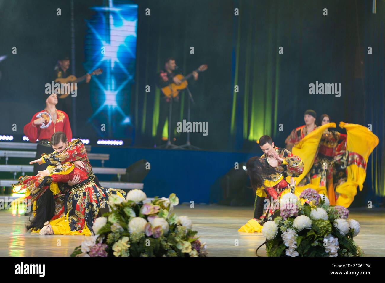 A team of musicians and singers perform on stage in front of the ...