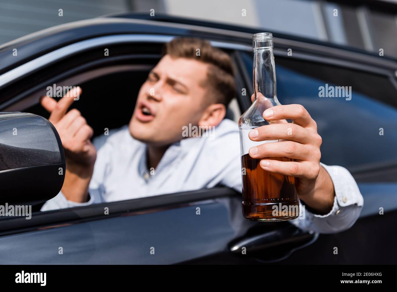 drunk man with bottle of alcohol showing come here gesture while ...