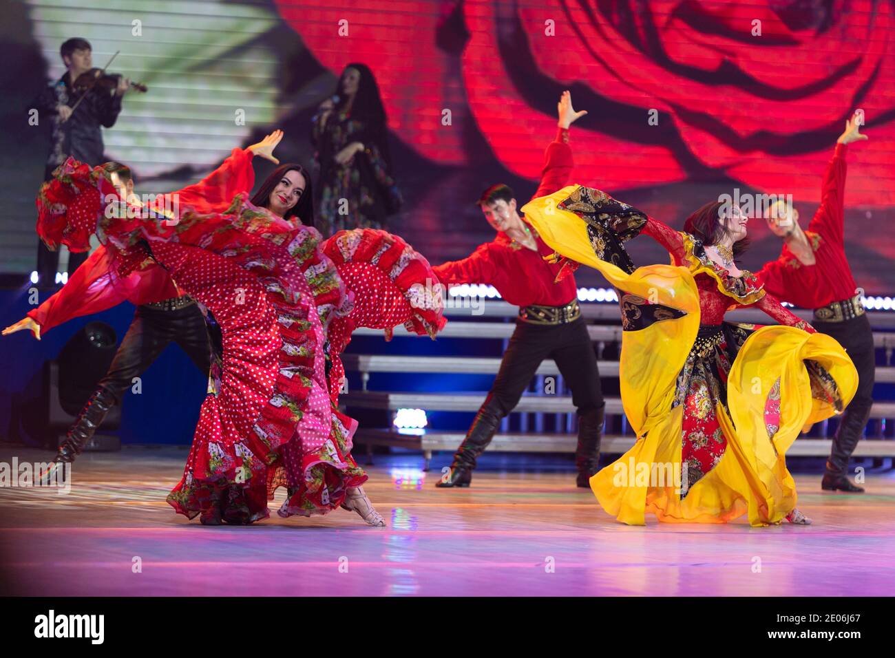 A team of musicians and singers perform on stage in front of the ...