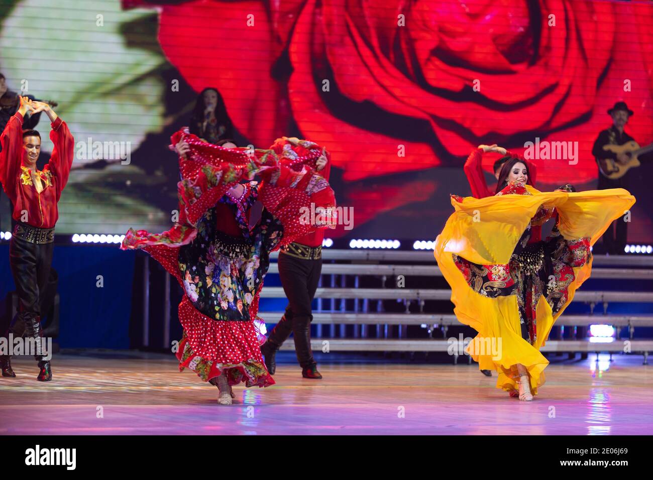 A team of musicians and singers perform on stage in front of the ...