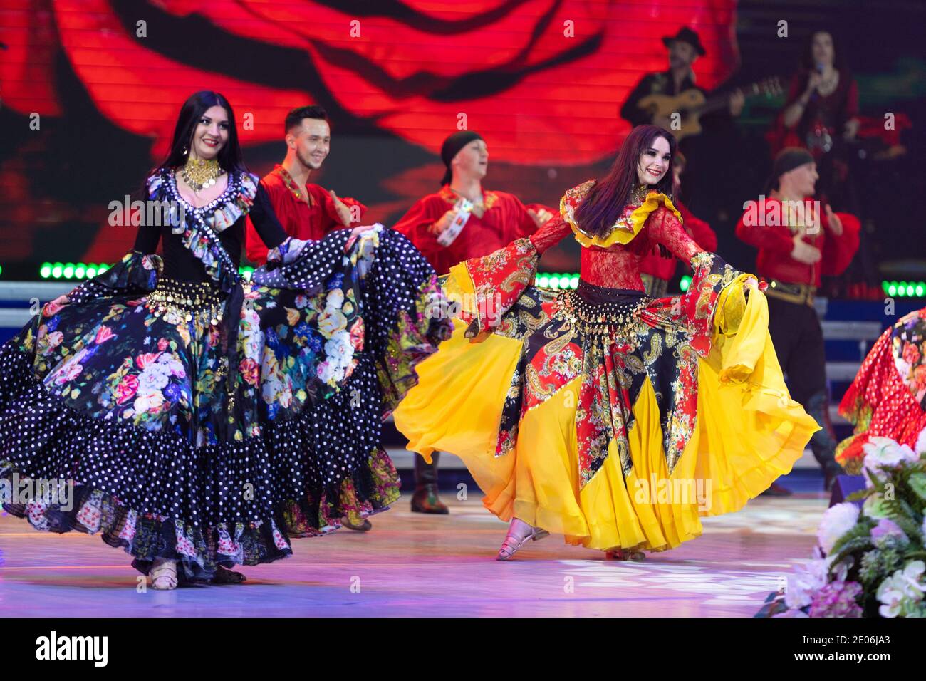 A team of musicians and singers perform on stage in front of the ...