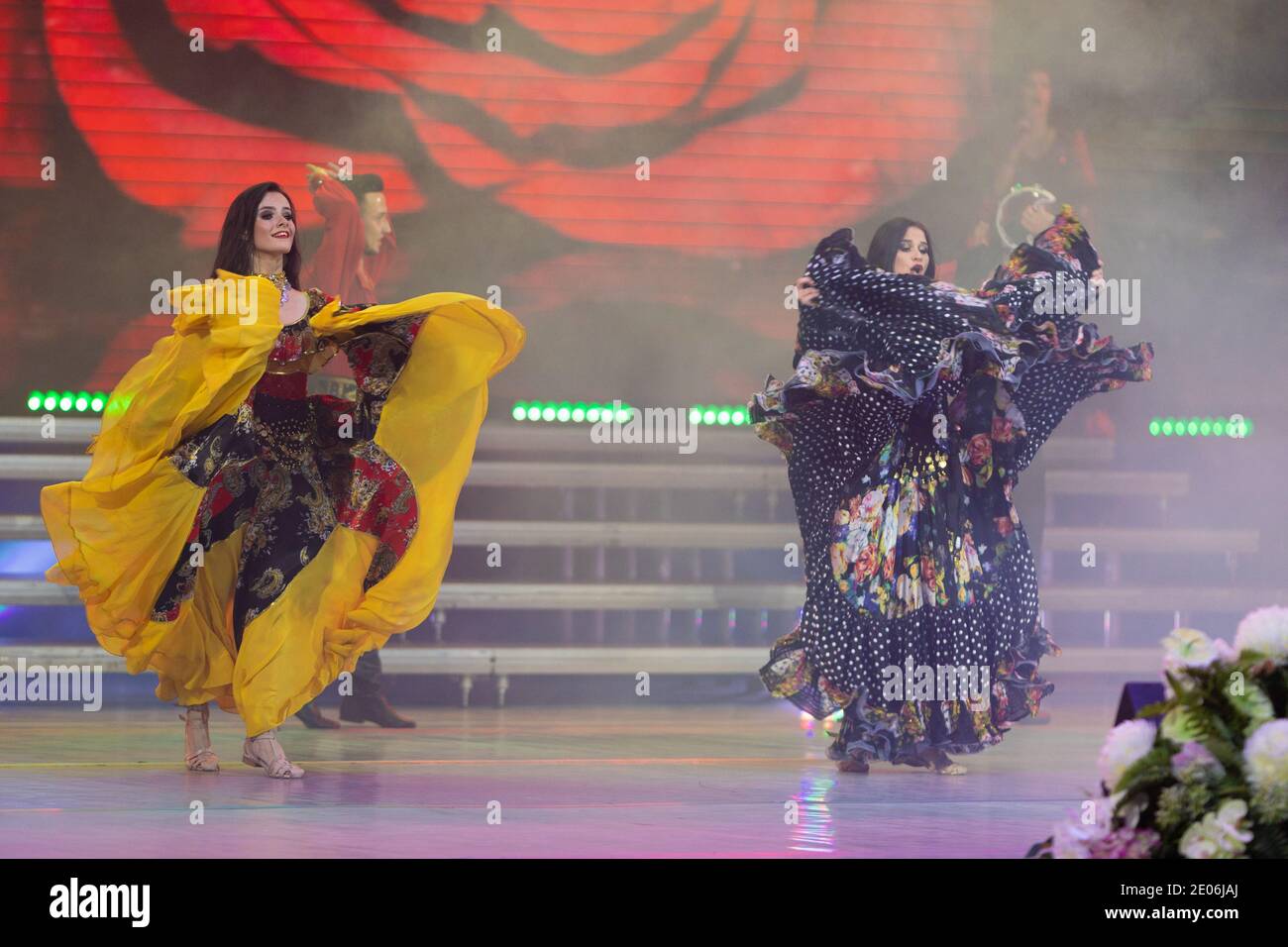 A team of musicians and singers perform on stage in front of the ...