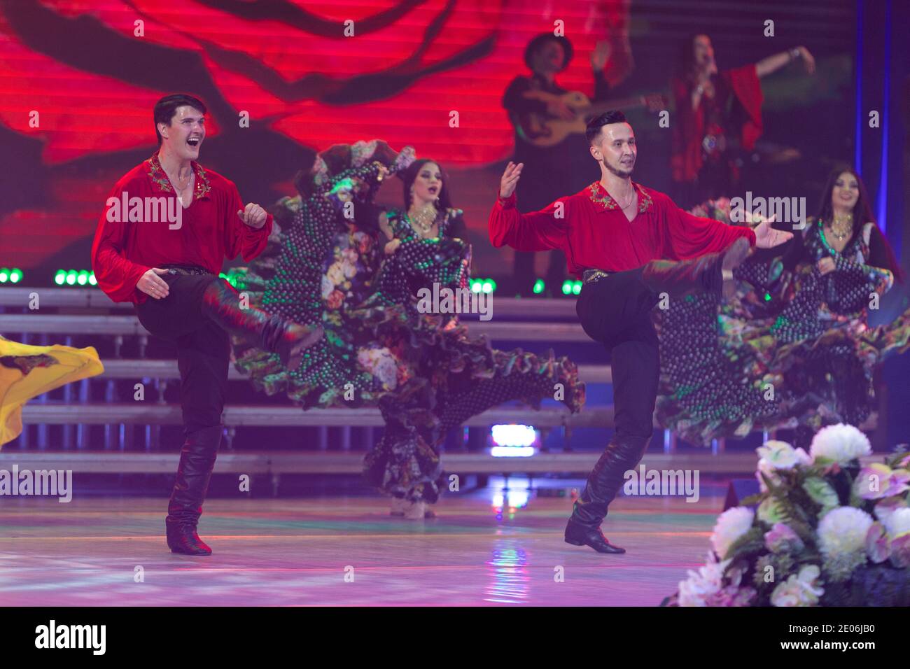 A team of musicians and singers perform on stage in front of the ...