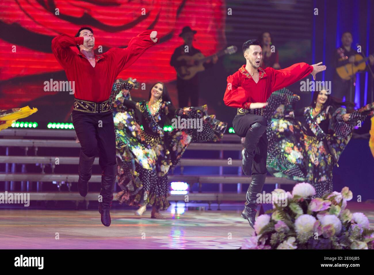 A team of musicians and singers perform on stage in front of the ...
