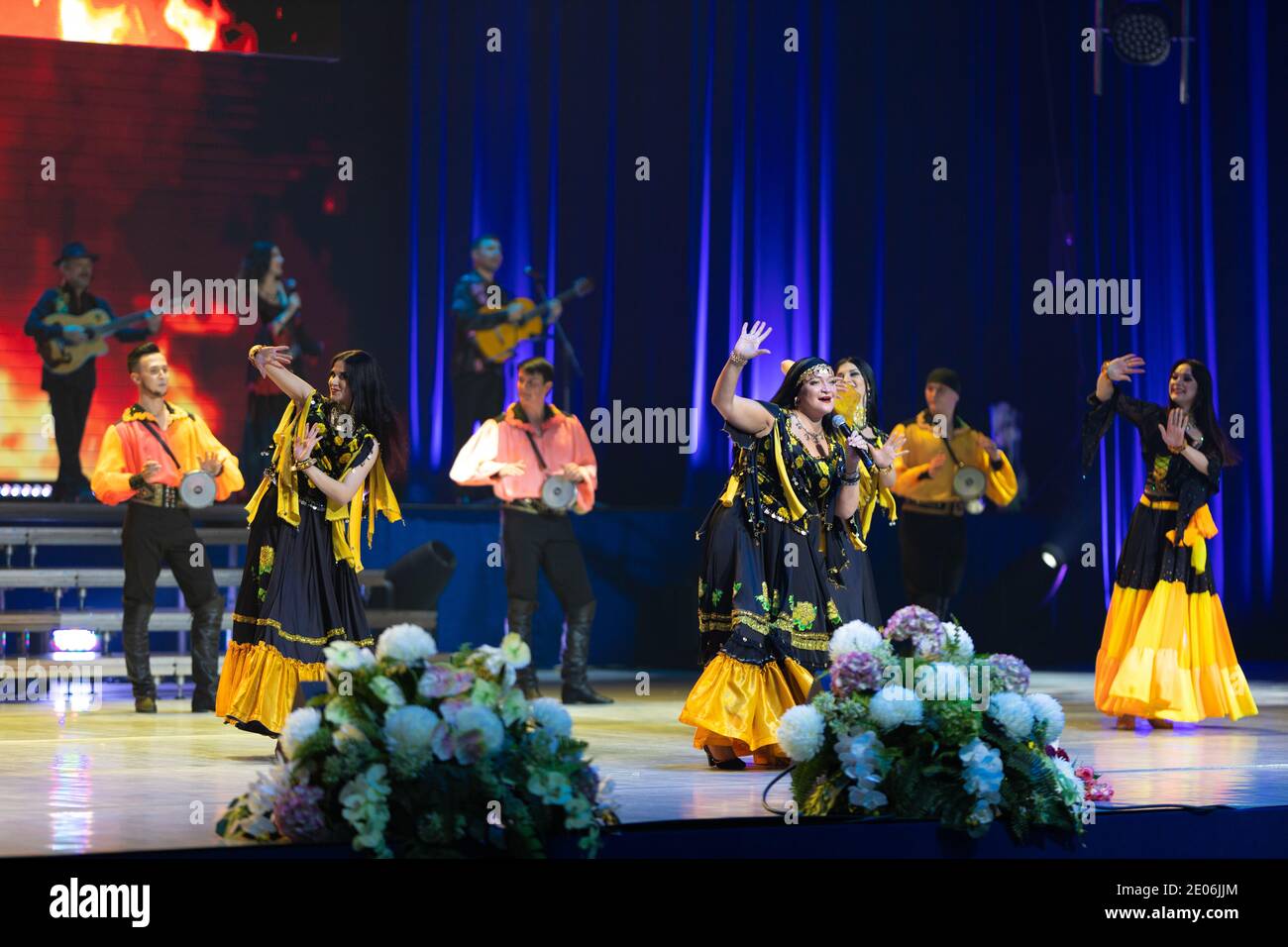 A team of musicians, singers and dancers in gypsy costumes singing and ...