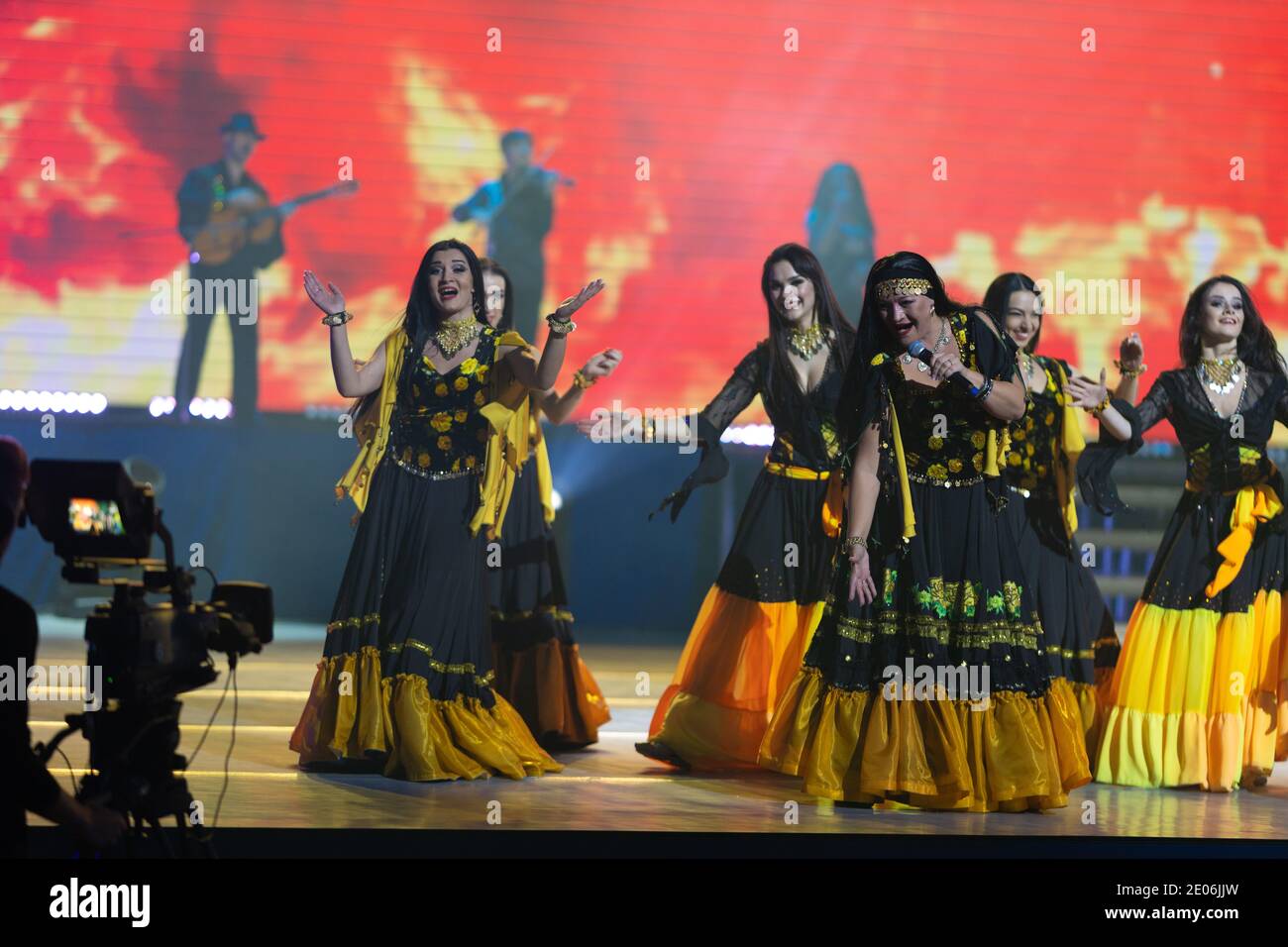 A team of musicians, singers and dancers in gypsy costumes singing and ...