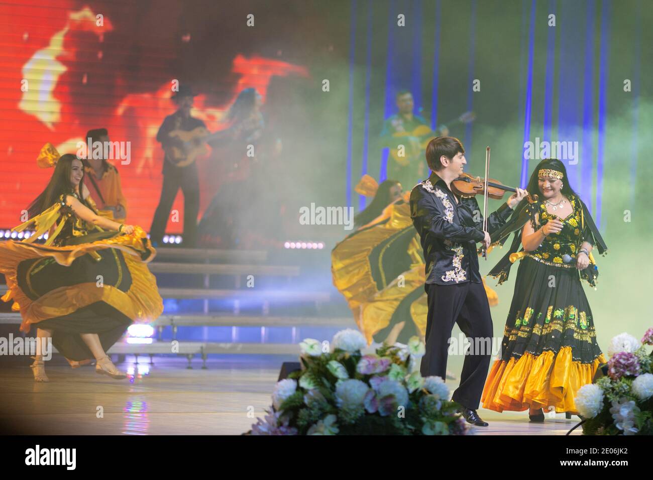 A team of musicians, singers and dancers in gypsy costumes singing and ...