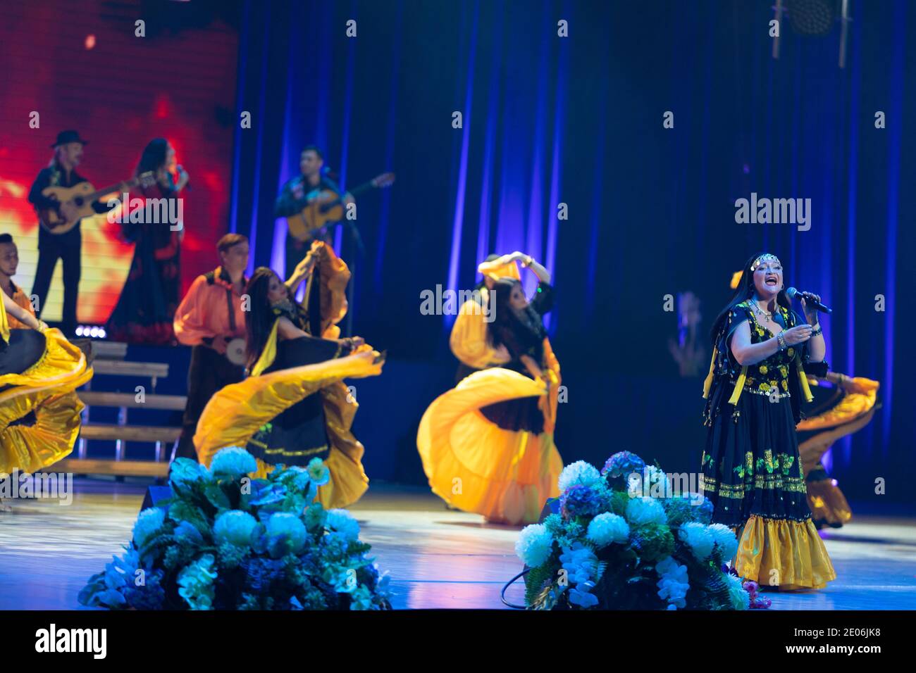 A team of musicians, singers and dancers in gypsy costumes singing and ...