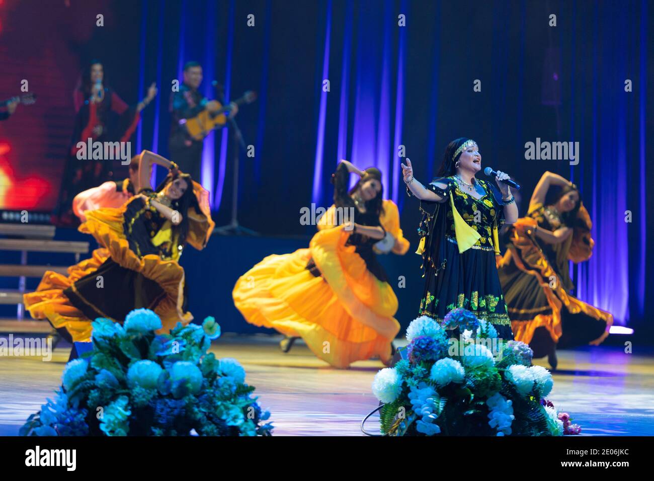 A team of musicians, singers and dancers in gypsy costumes singing and ...