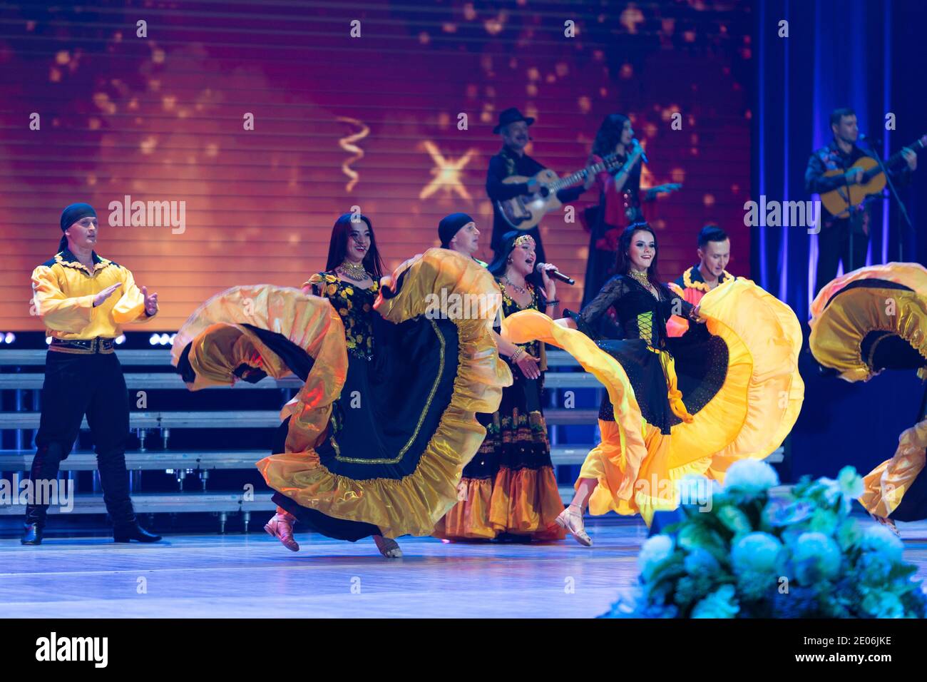 A team of musicians, singers and dancers in gypsy costumes singing and ...