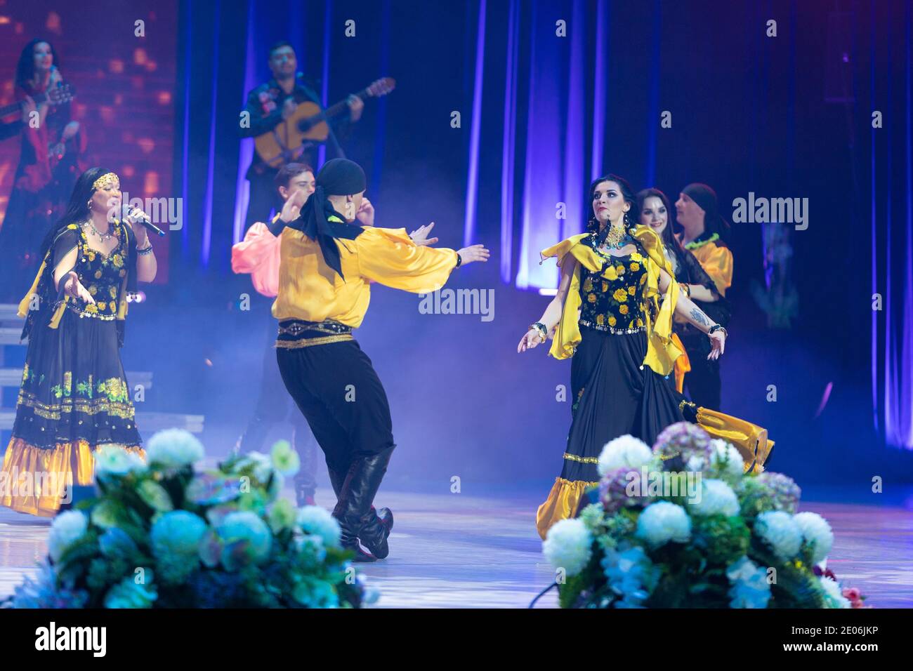 A team of musicians, singers and dancers in gypsy costumes singing and ...