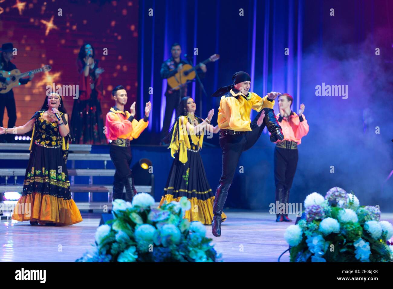 A team of musicians, singers and dancers in gypsy costumes singing and ...