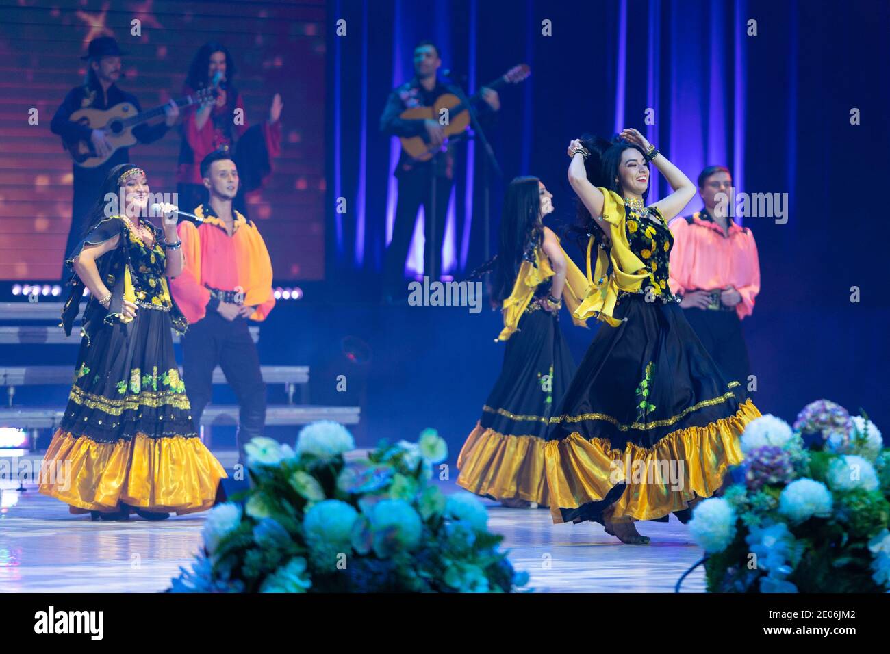 A team of musicians, singers and dancers in gypsy costumes singing and ...