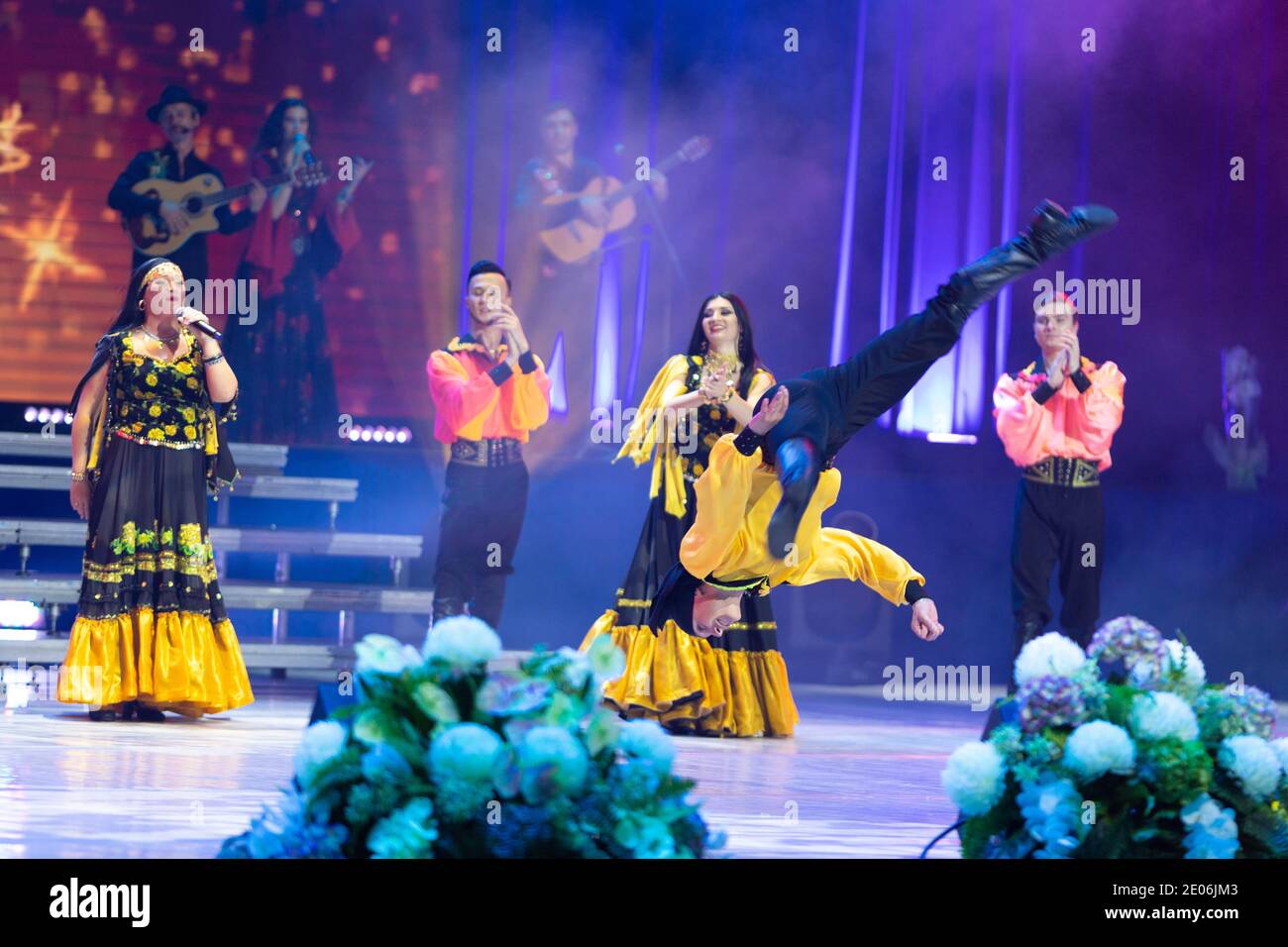 A team of musicians, singers and dancers in gypsy costumes singing and ...