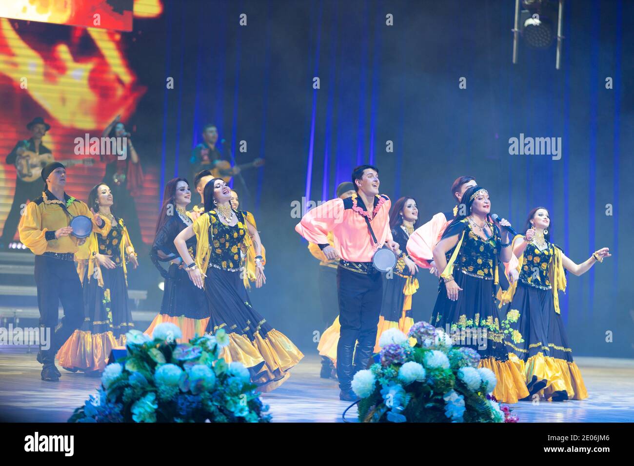 A team of musicians, singers and dancers in gypsy costumes singing and ...