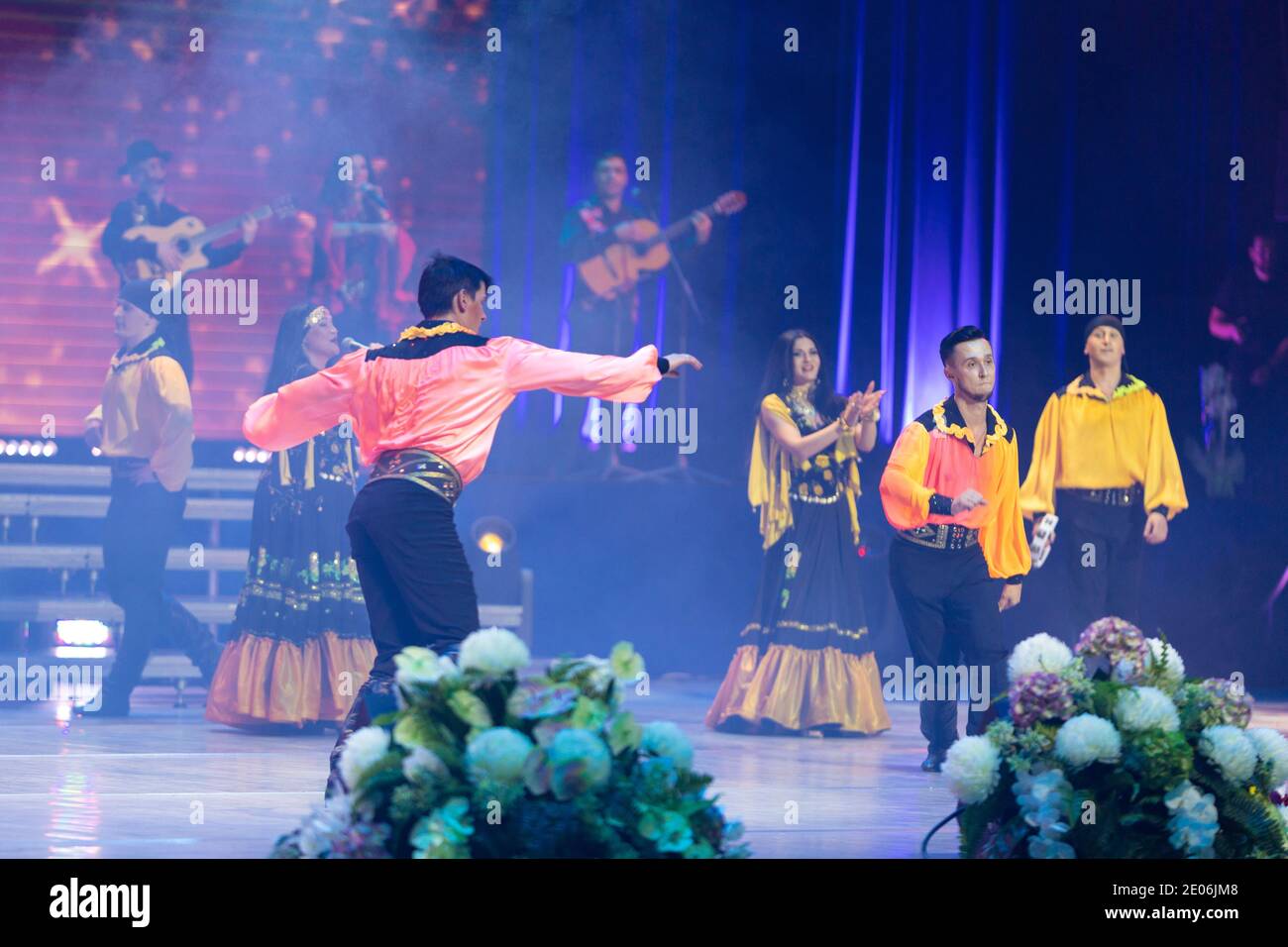A team of musicians, singers and dancers in gypsy costumes singing and ...