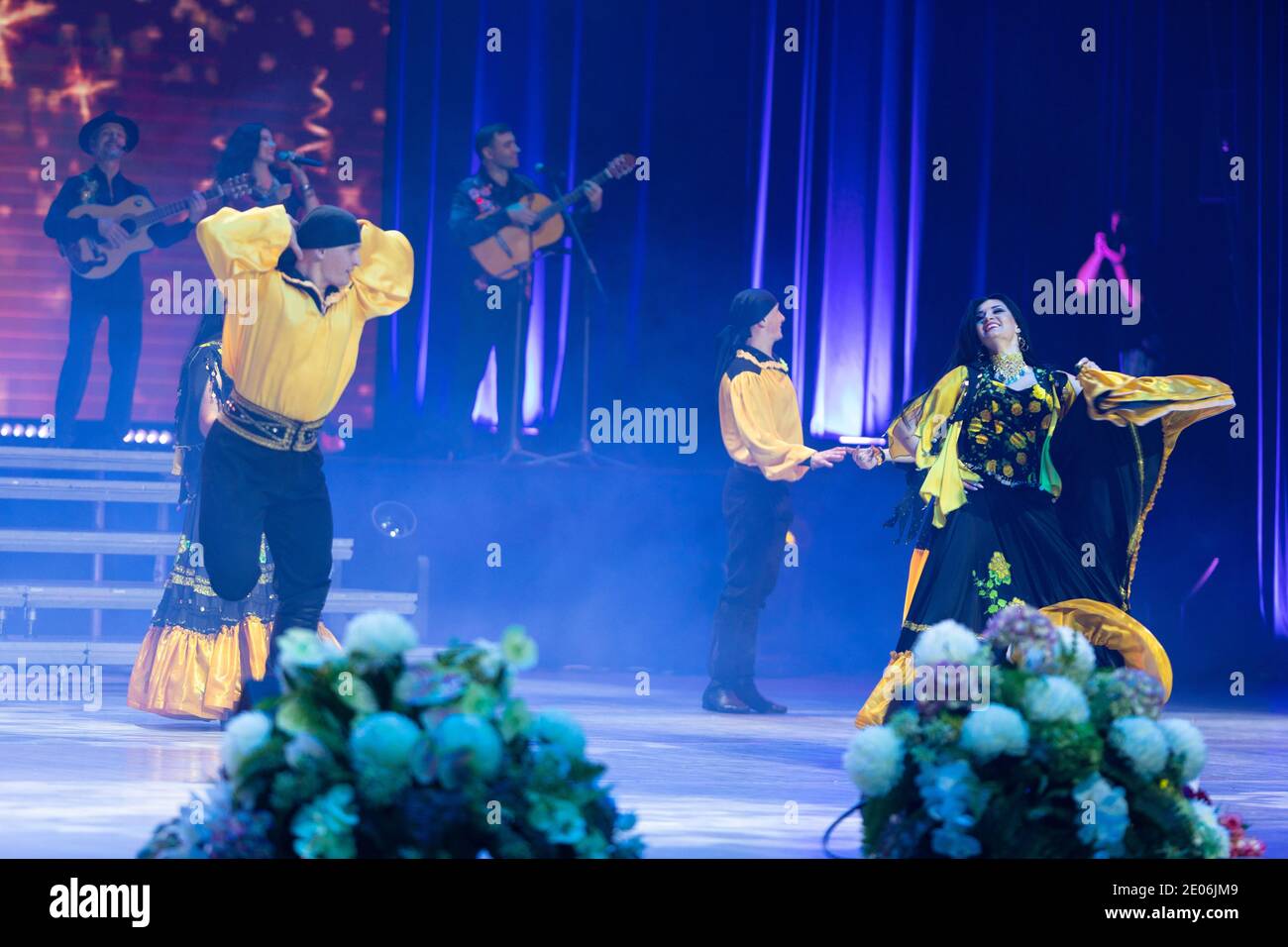 A team of musicians, singers and dancers in gypsy costumes singing and ...