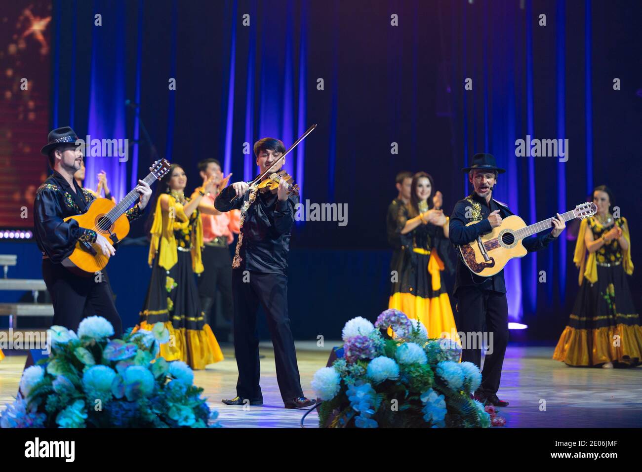 A team of musicians, singers and dancers in gypsy costumes singing and ...