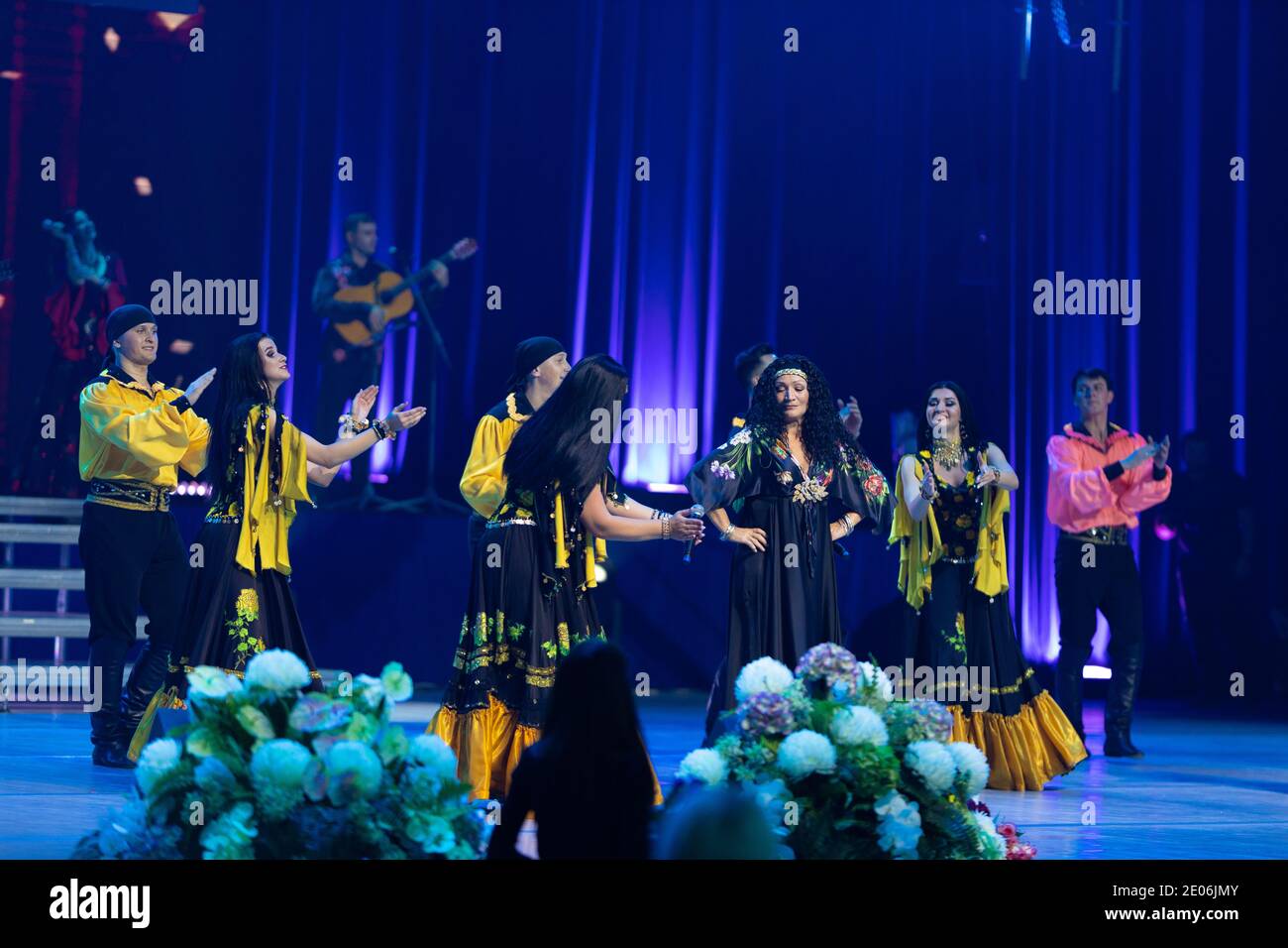 A team of musicians, singers and dancers in gypsy costumes singing and ...