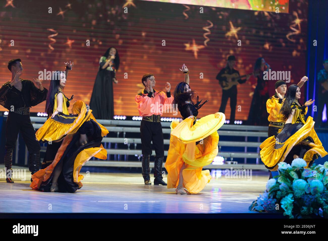 A team of musicians, singers and dancers in gypsy costumes singing and ...
