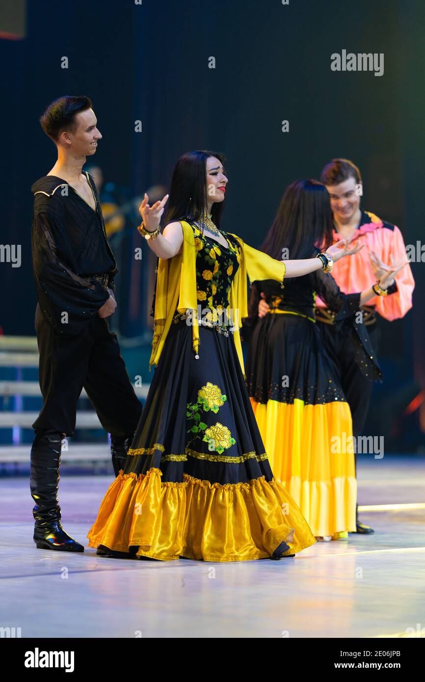 A team of musicians, singers and dancers in gypsy costumes singing and ...