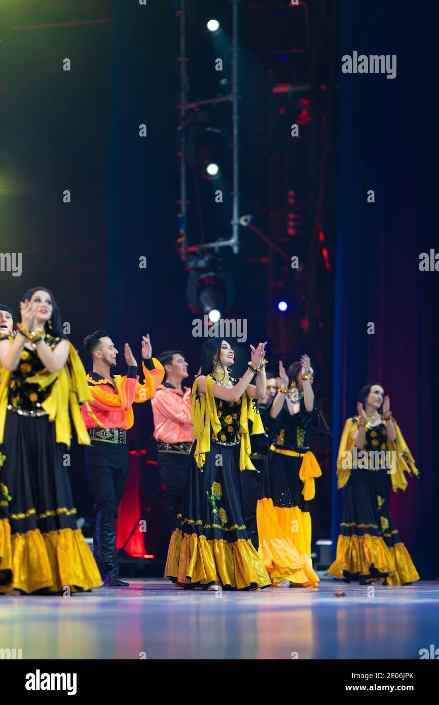 A team of musicians, singers and dancers in gypsy costumes singing and ...