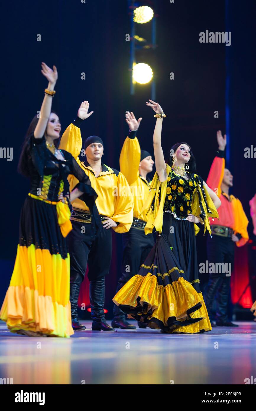 A team of musicians, singers and dancers in gypsy costumes singing and ...