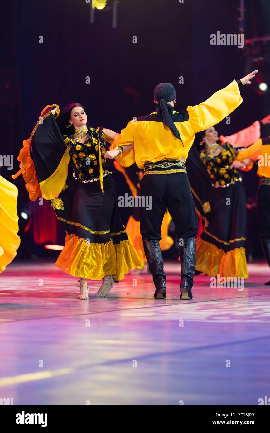 A team of musicians, singers and dancers in gypsy costumes singing and ...