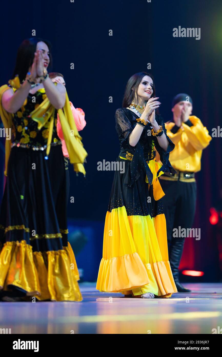 A team of musicians, singers and dancers in gypsy costumes singing and ...
