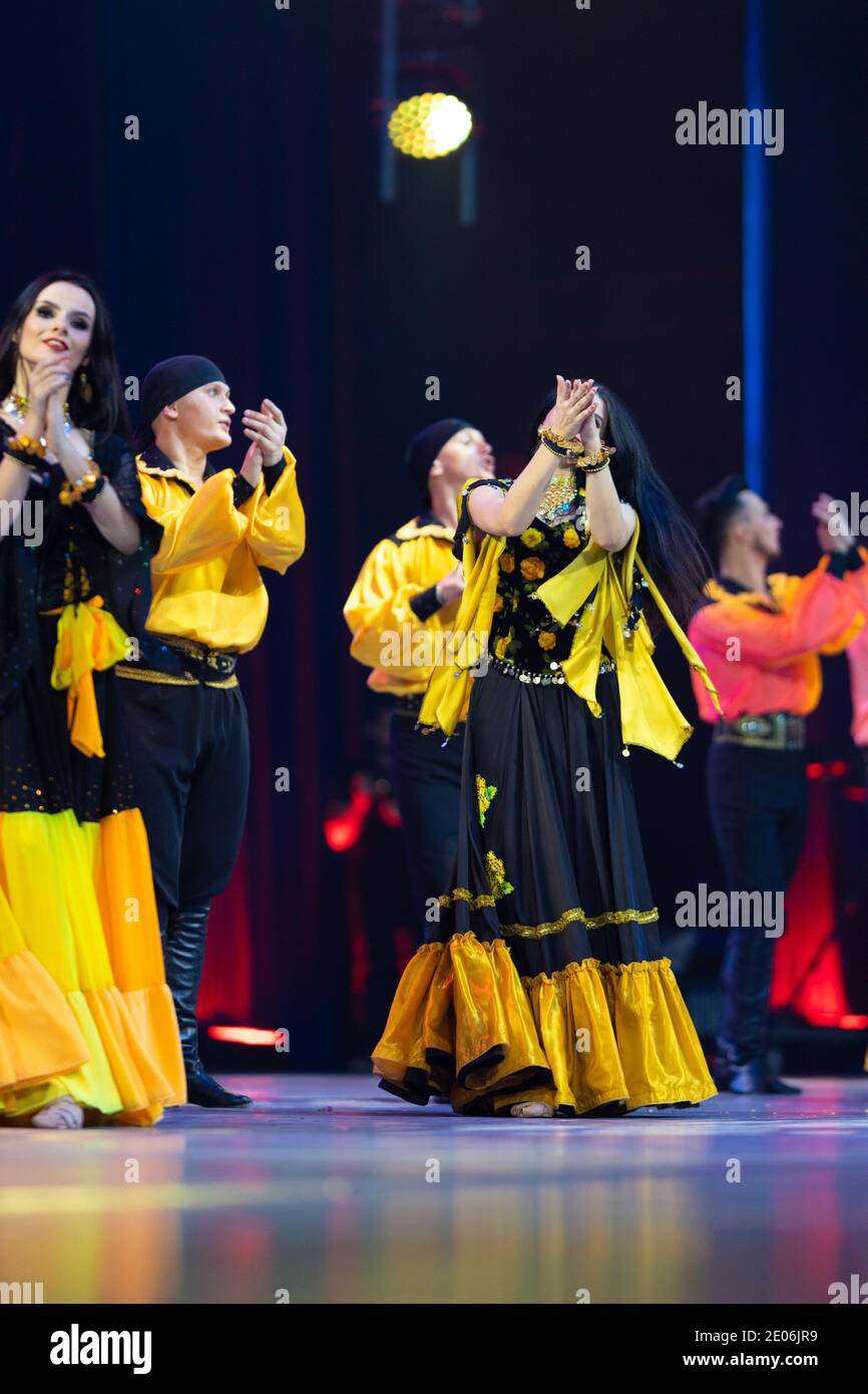 A team of musicians, singers and dancers in gypsy costumes singing and ...