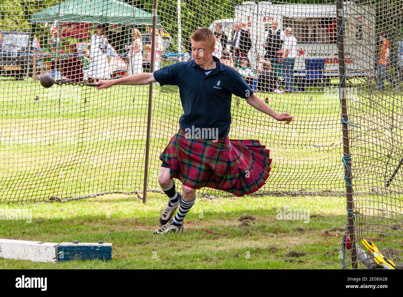 A competitor competing in the Throwing the Hammer contest during the ...