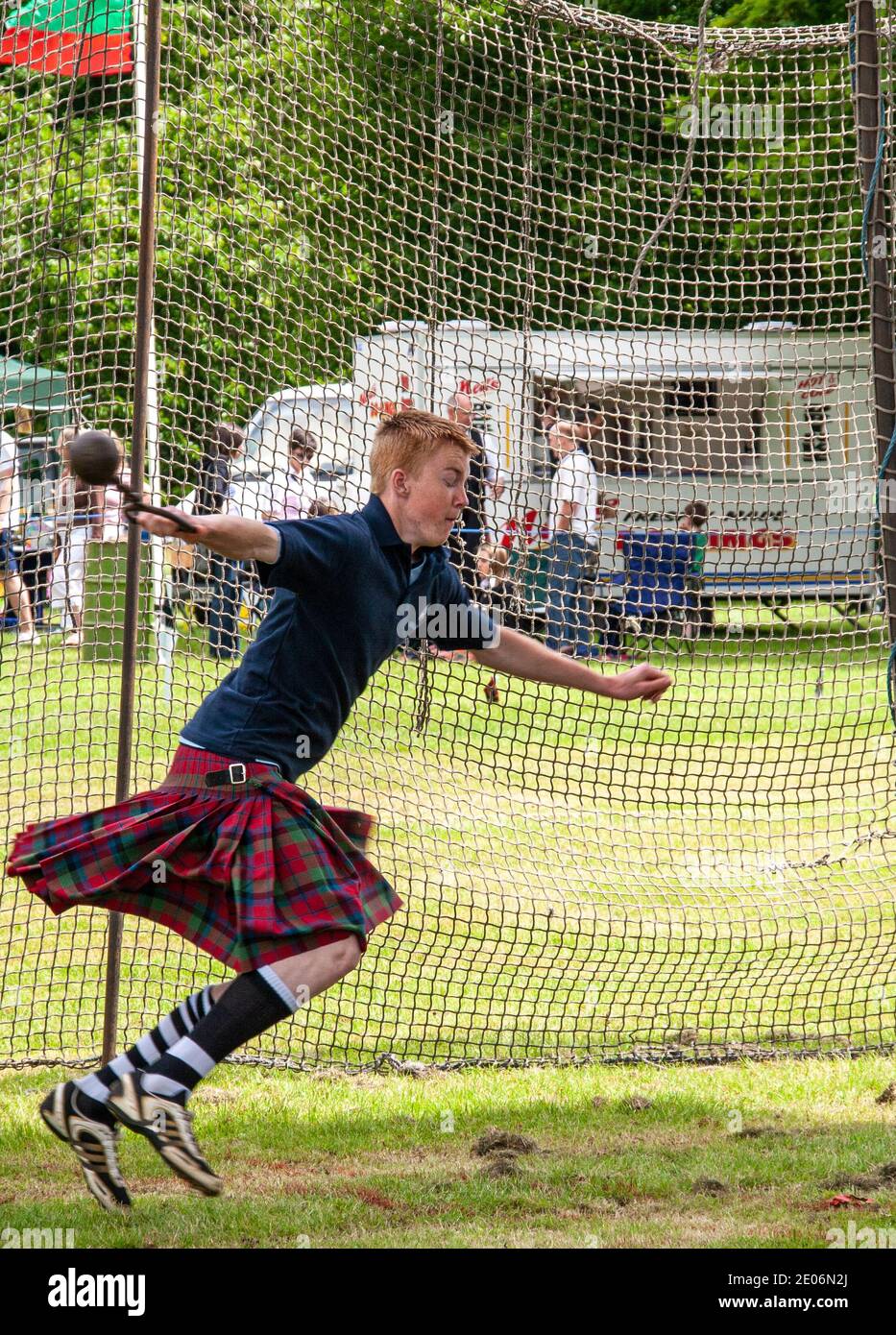 A competitor competing in the Throwing the Hammer contest during the ...