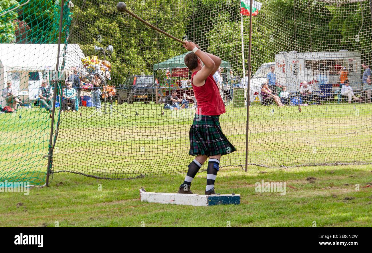 A competitor competing in the Throwing the Hammer contest during the ...