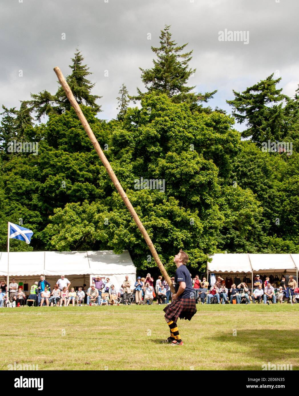 A competitor competing in the Tossing of the Caber contest during the ...