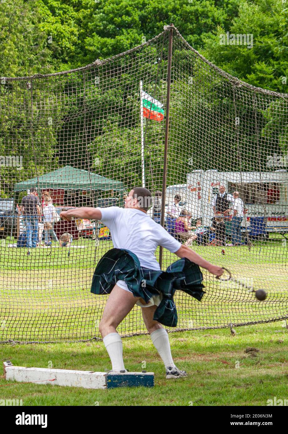 A competitor competing in the Throwing the Hammer contest during the ...