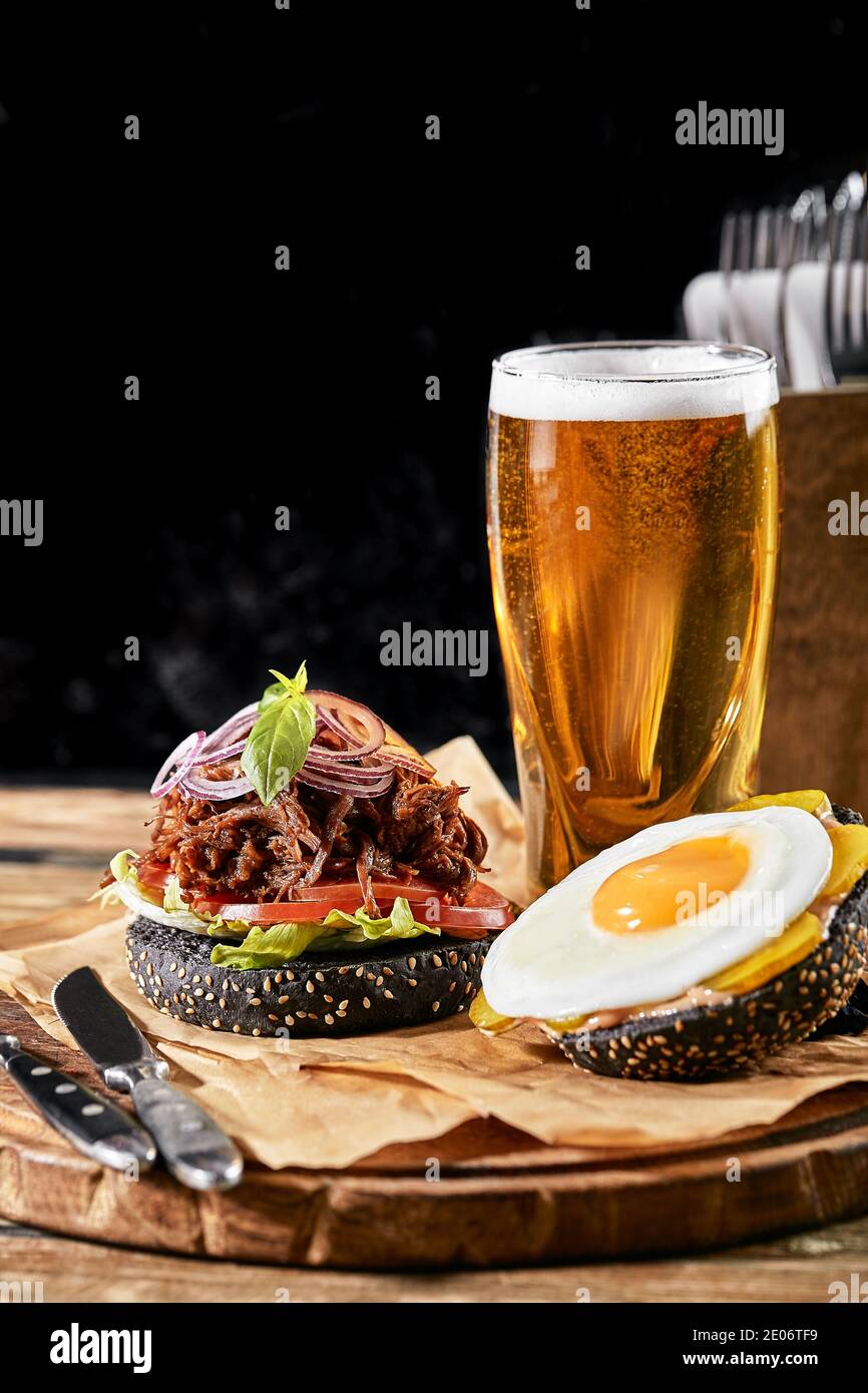 Set of hamburger with egg and beer. A standard set of drinks and food ...