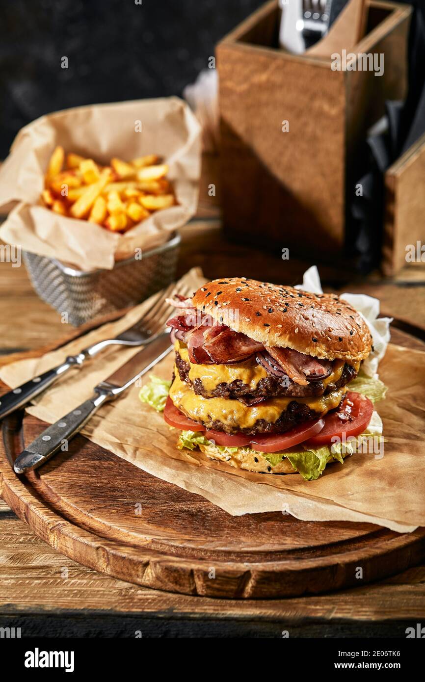 The concept of American fast food. A juicy American burger with two ...
