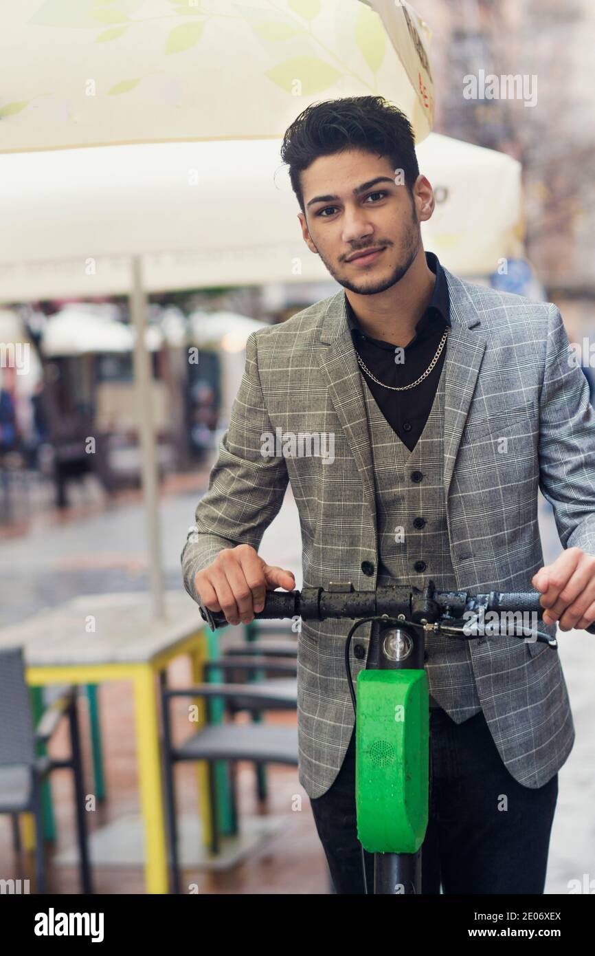 Young man using an electric scooter to move around city Stock Photo - Alamy