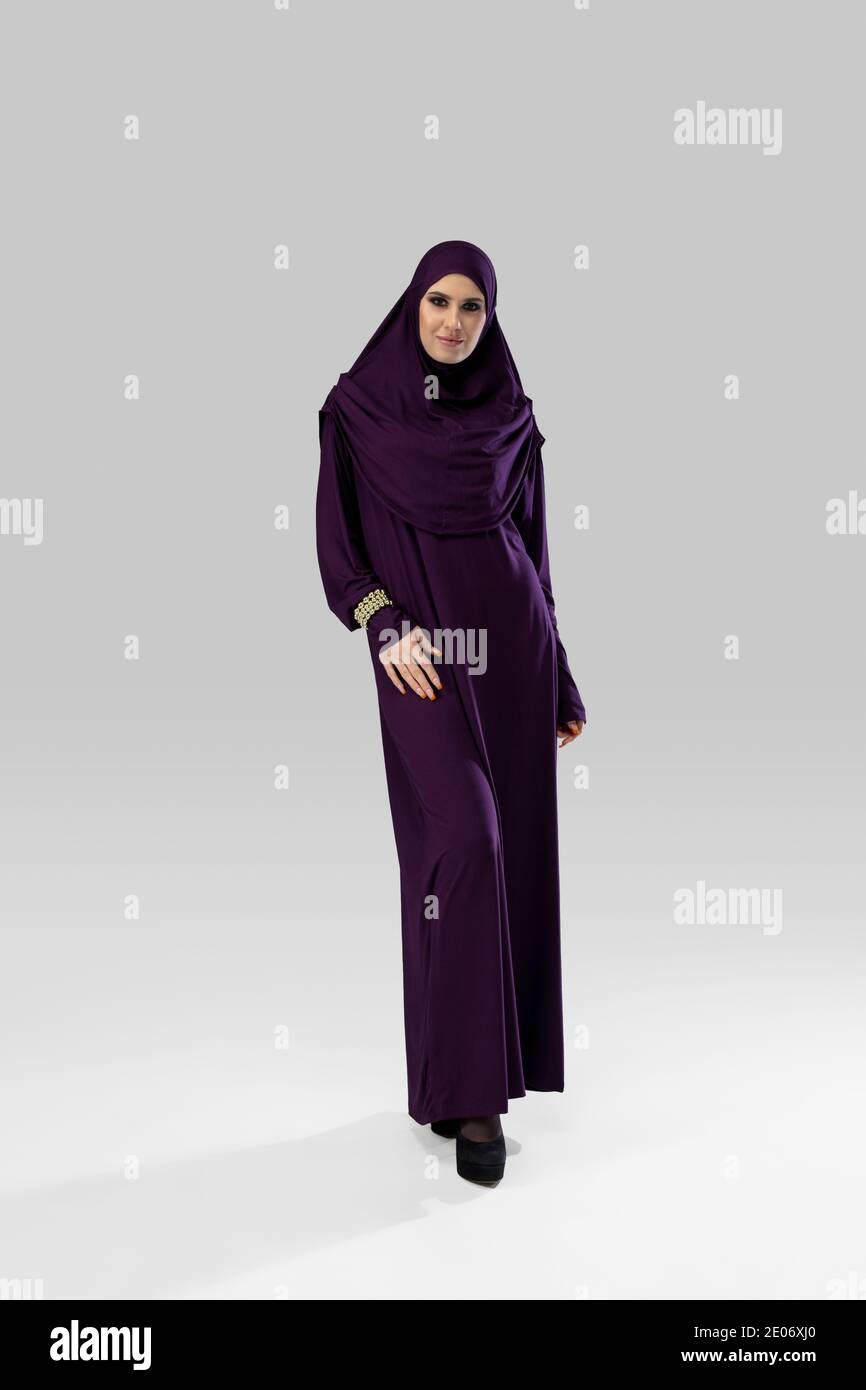 Queen. Beautiful arab woman posing in stylish hijab isolated on studio ...
