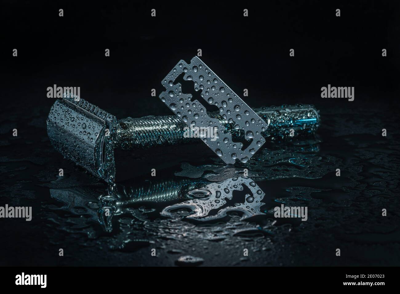 A classic razor blade with a safety razor in the background, vintage ...