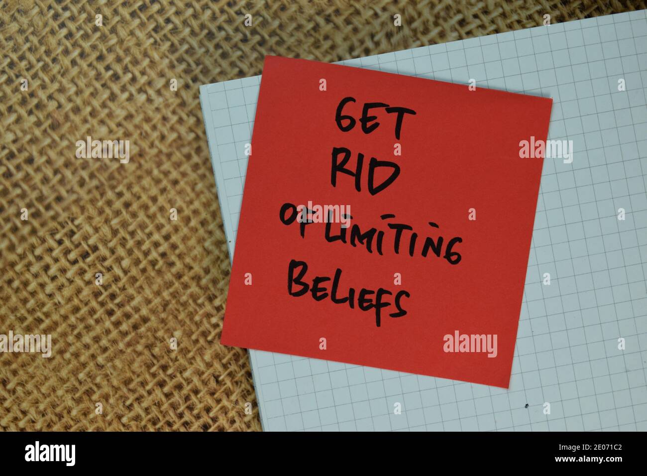 Get Rid Of limiting Beliefs write on sticky notes isolated on Brown ...