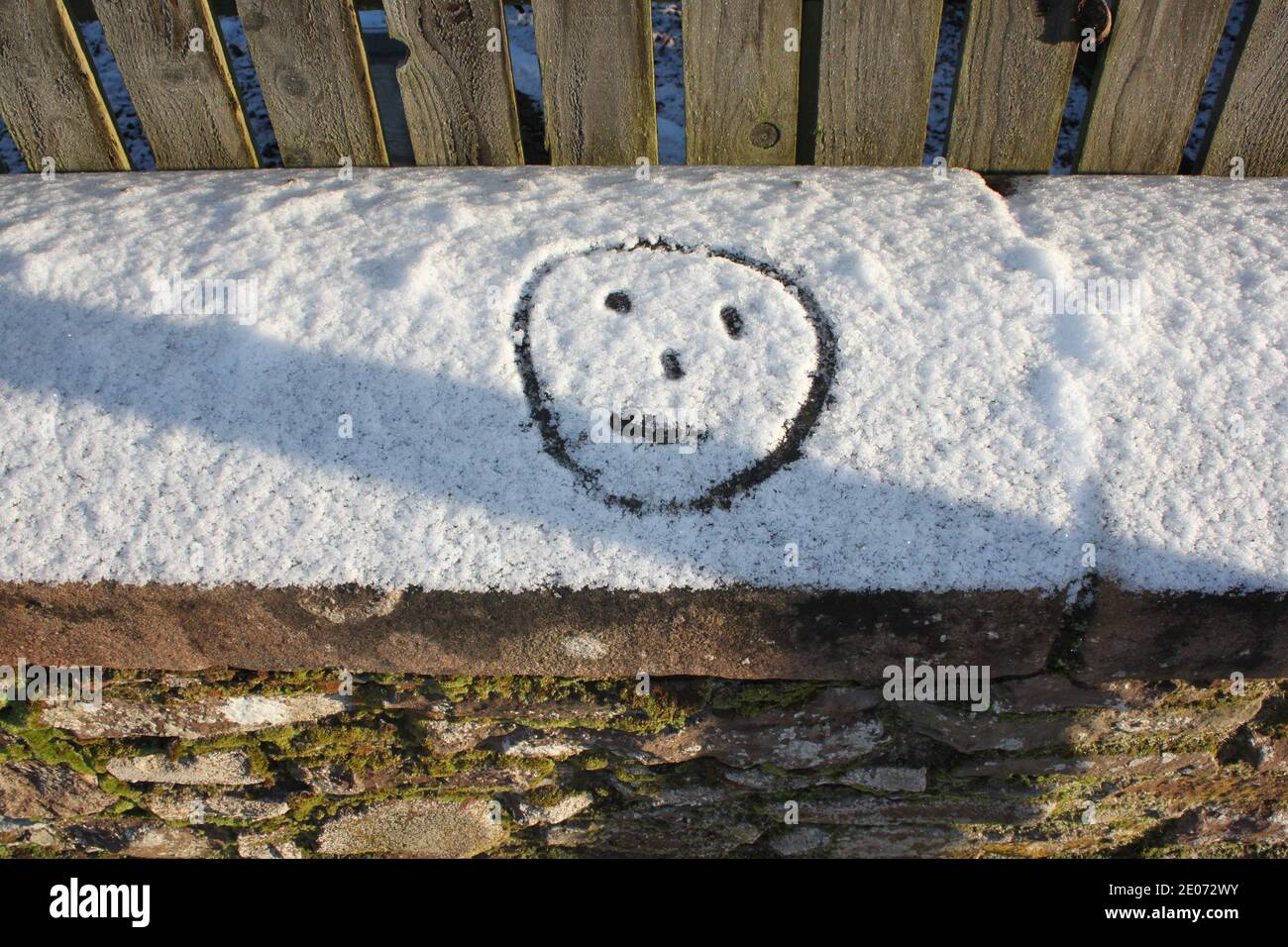 Smiley face imprinted into snow hi-res stock photography and images - Alamy