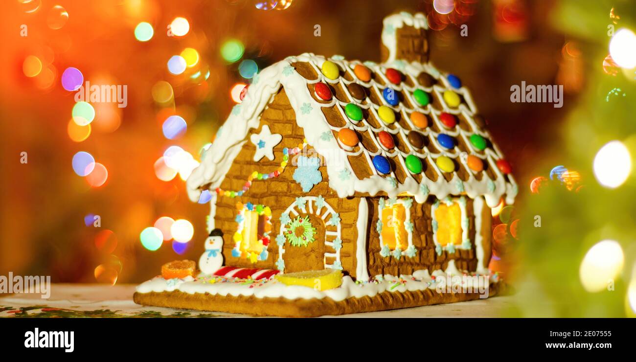 gingerbread house with blurred garland lights background Stock Photo ...