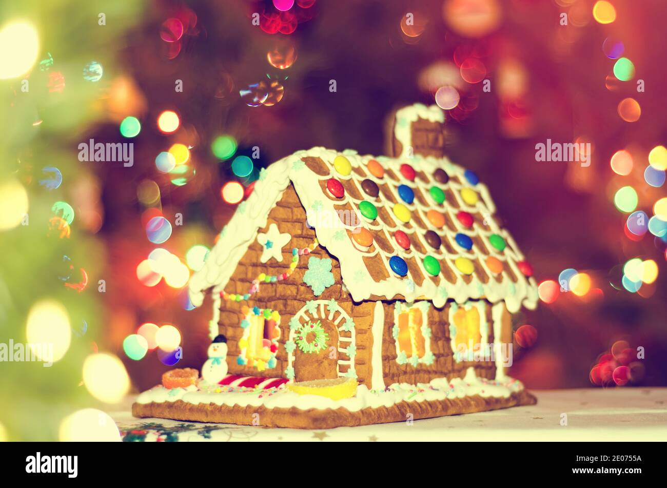 gingerbread house with blurred garland lights background Stock Photo ...