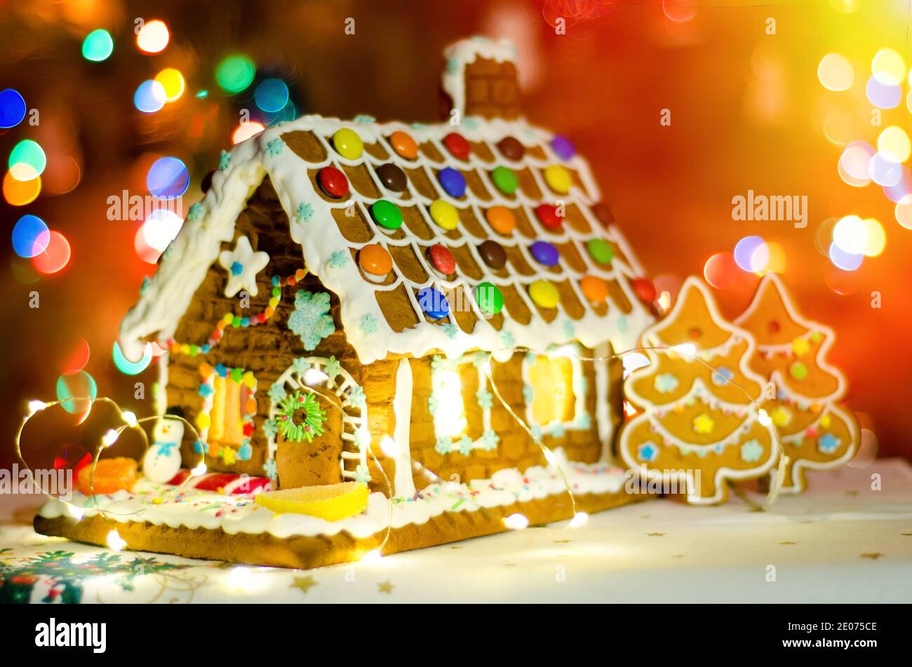 gingerbread house with blurred garland lights background Stock Photo ...