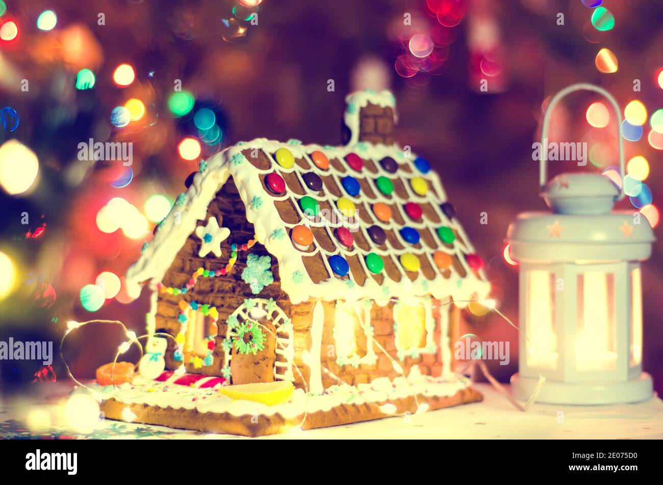 gingerbread house with garland lights and lantern Stock Photo - Alamy