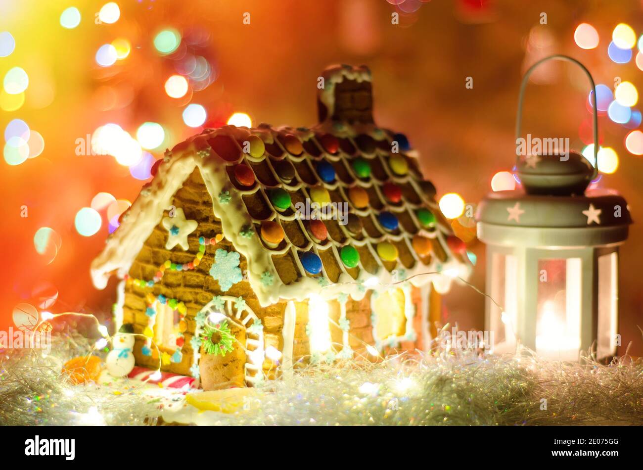 gingerbread house with garland lights and lantern Stock Photo - Alamy