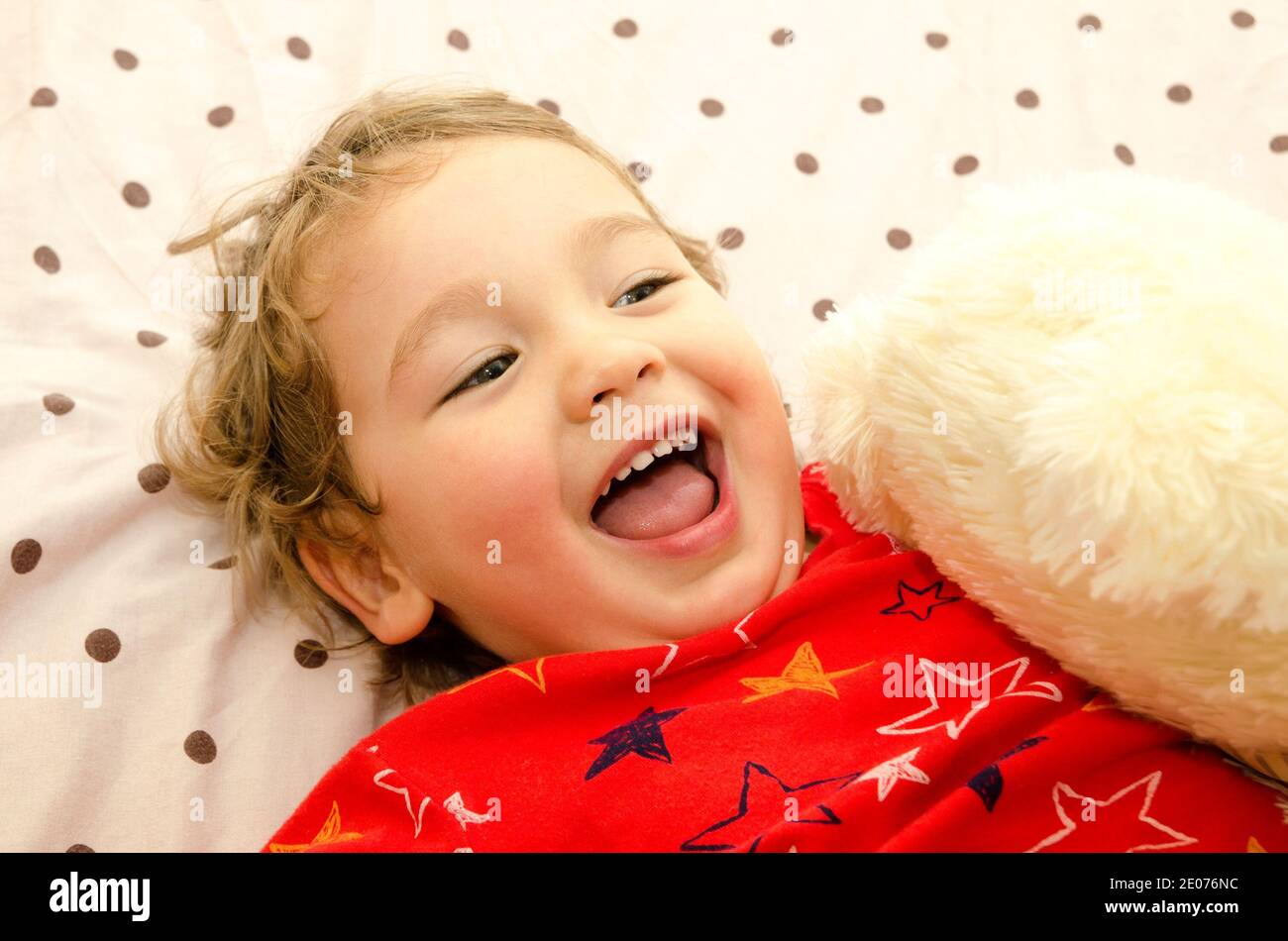 little boy smiling on the bed Stock Photo - Alamy