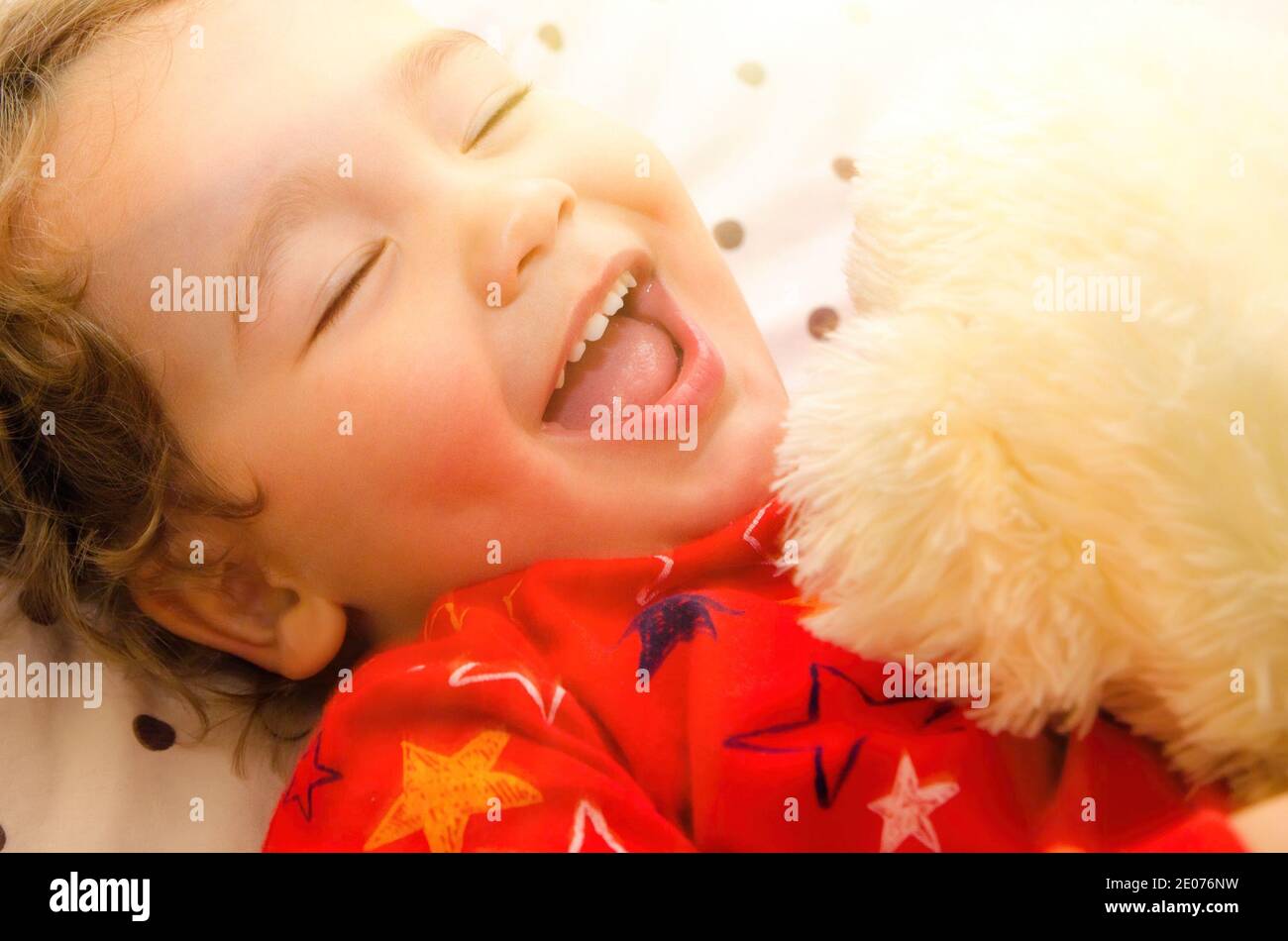 little boy smiling on the bed Stock Photo - Alamy