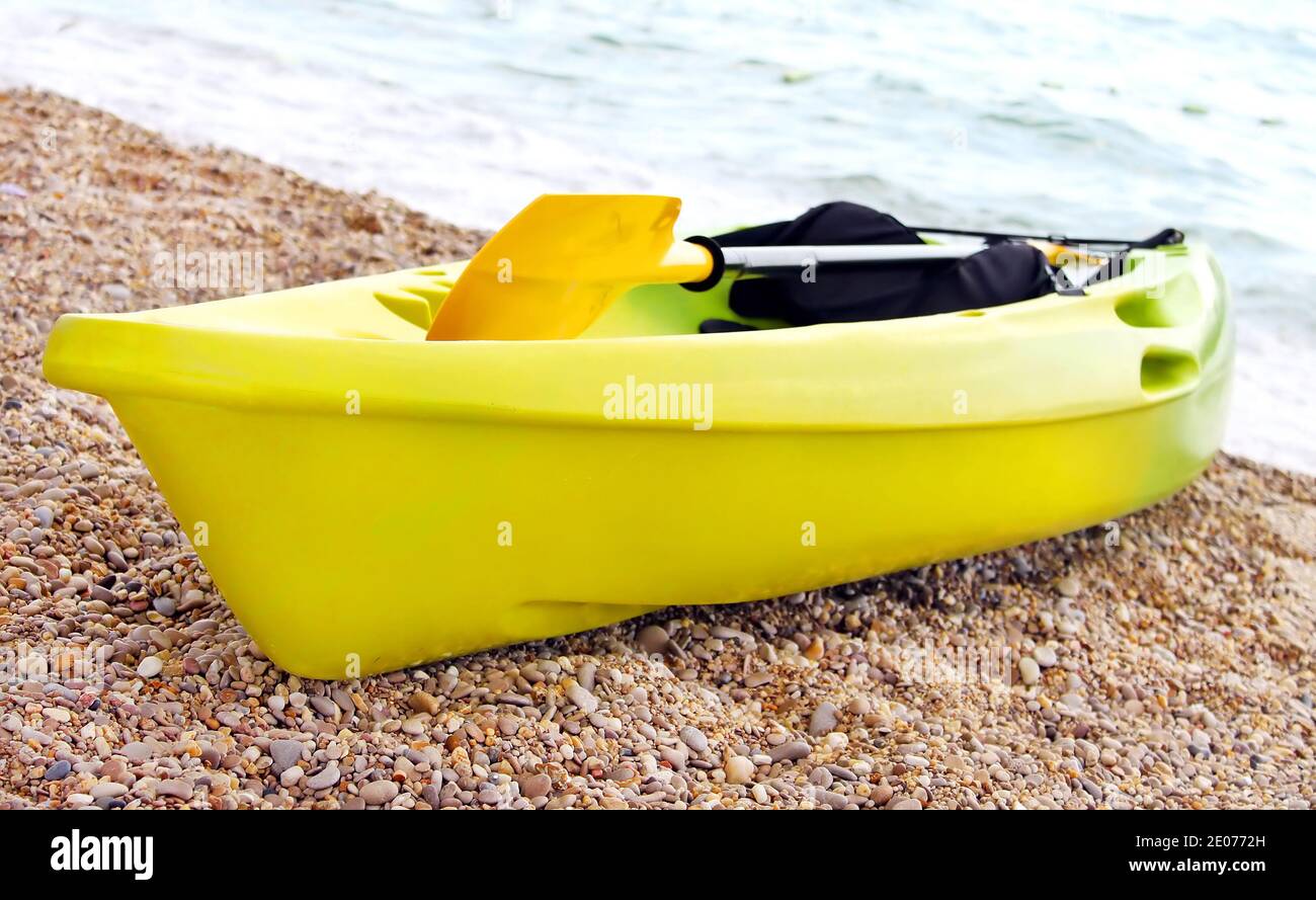 Yellow kayak on the beach Stock Photo - Alamy